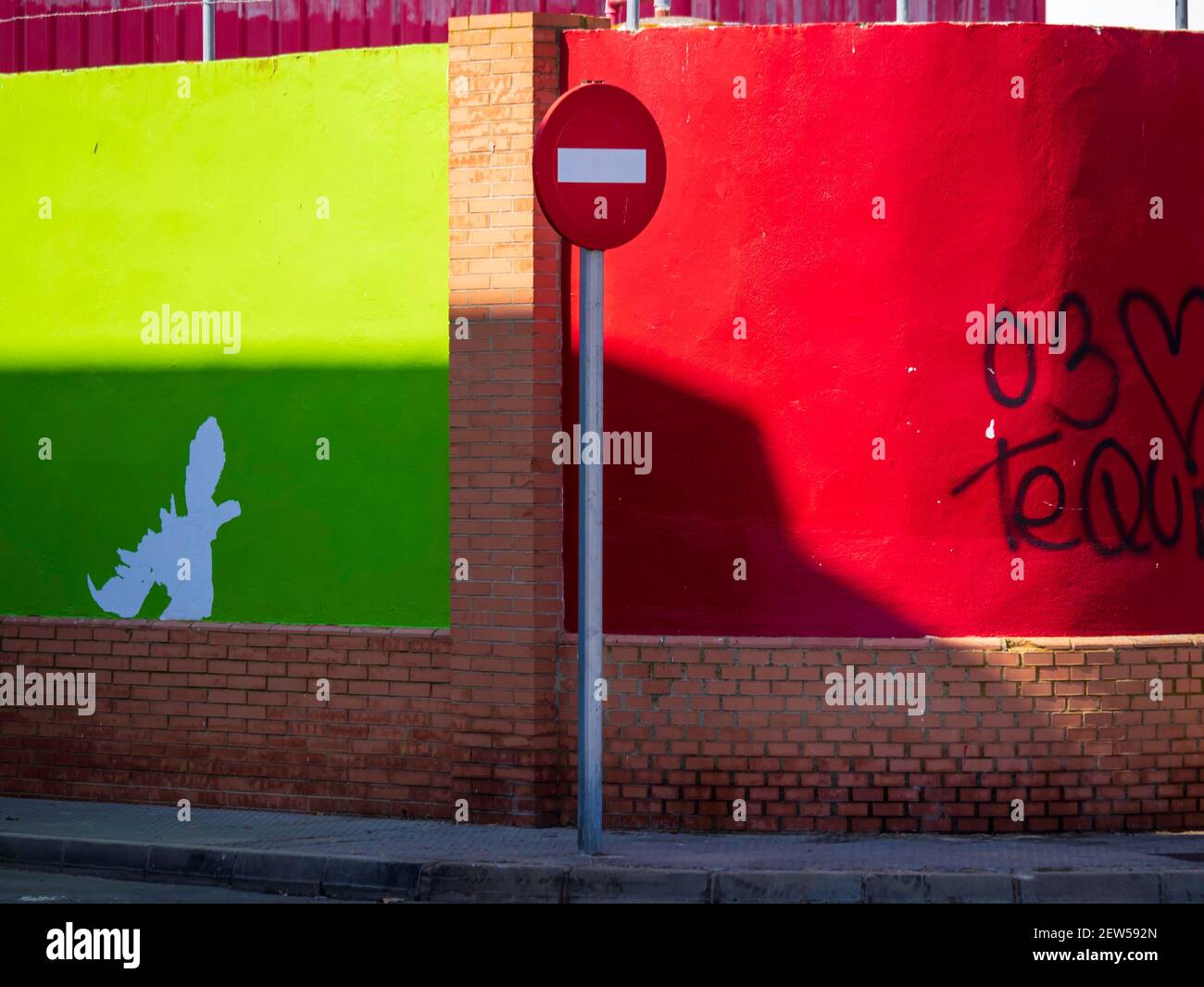 Prohibition traffic sign in a red and green facade Stock Photo - Alamy