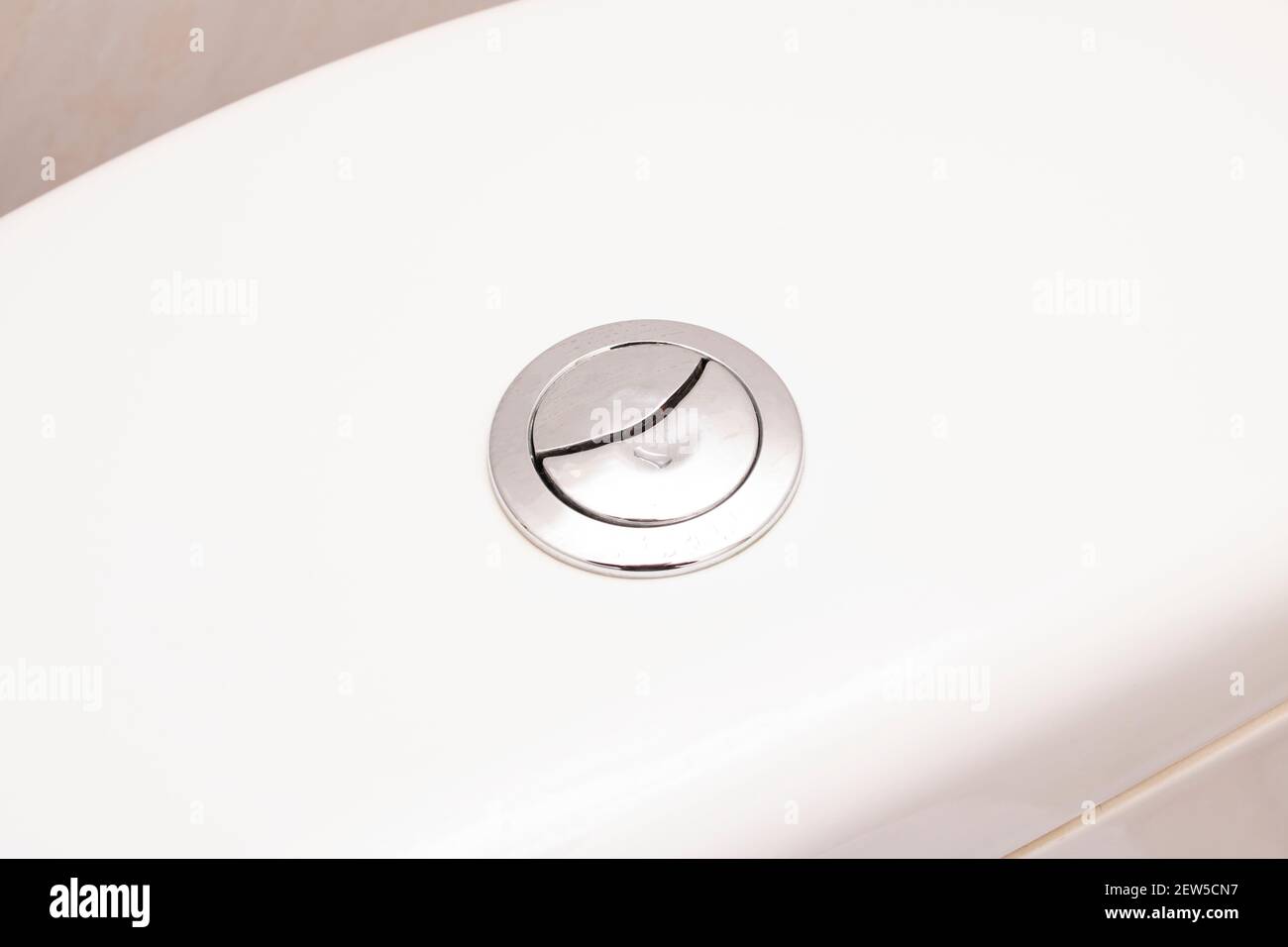 Flush button on a white toilet closeup Stock Photo - Alamy
