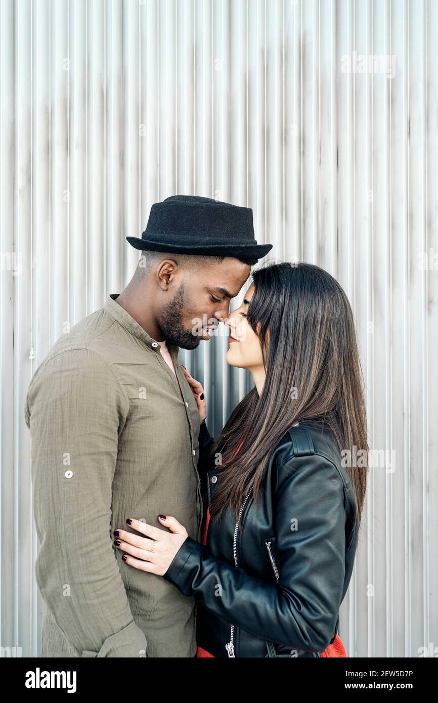 Young couple having romantic moments together in the street ...