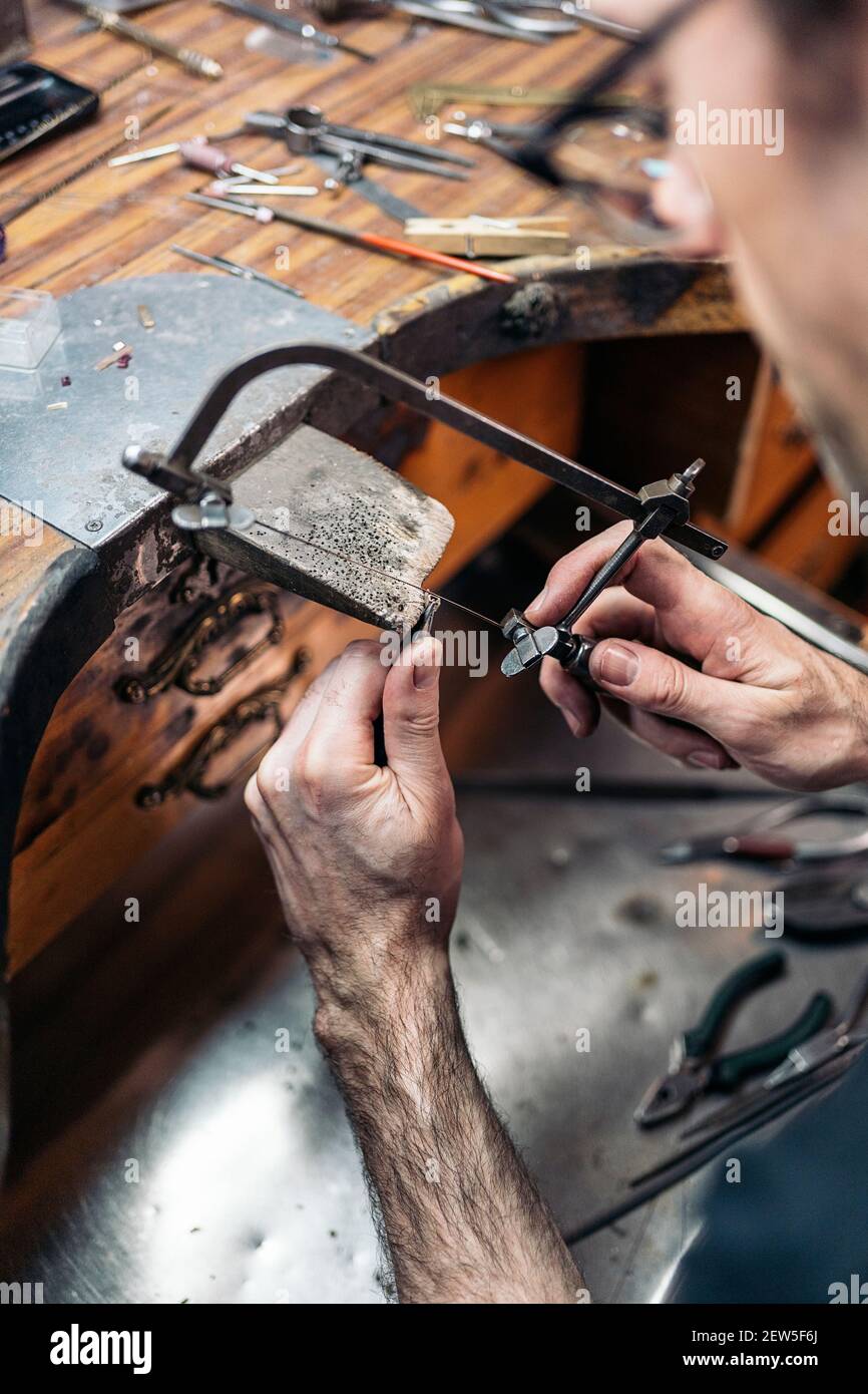 Stock photo of concentrated man working with tools in artisan workshop ...