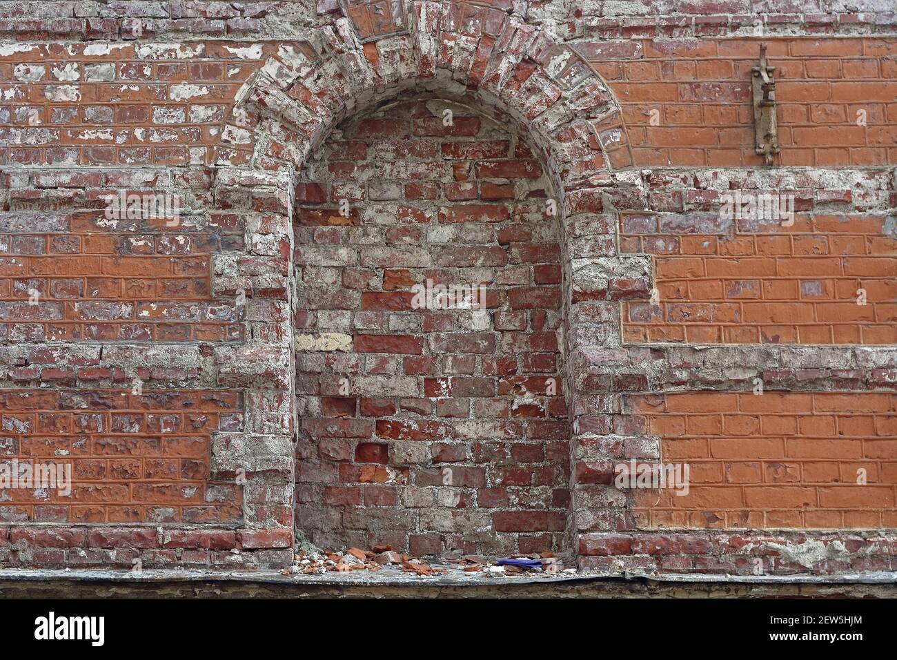Destroyed bricked window opening on a red brick wall in an old ...