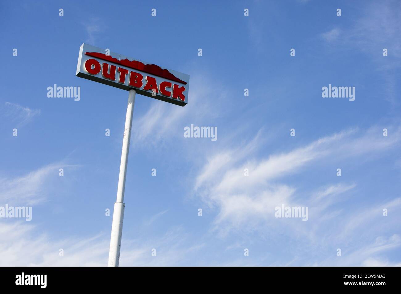 A logo sign outside of a Outback Steakhouse restaurant location in ...