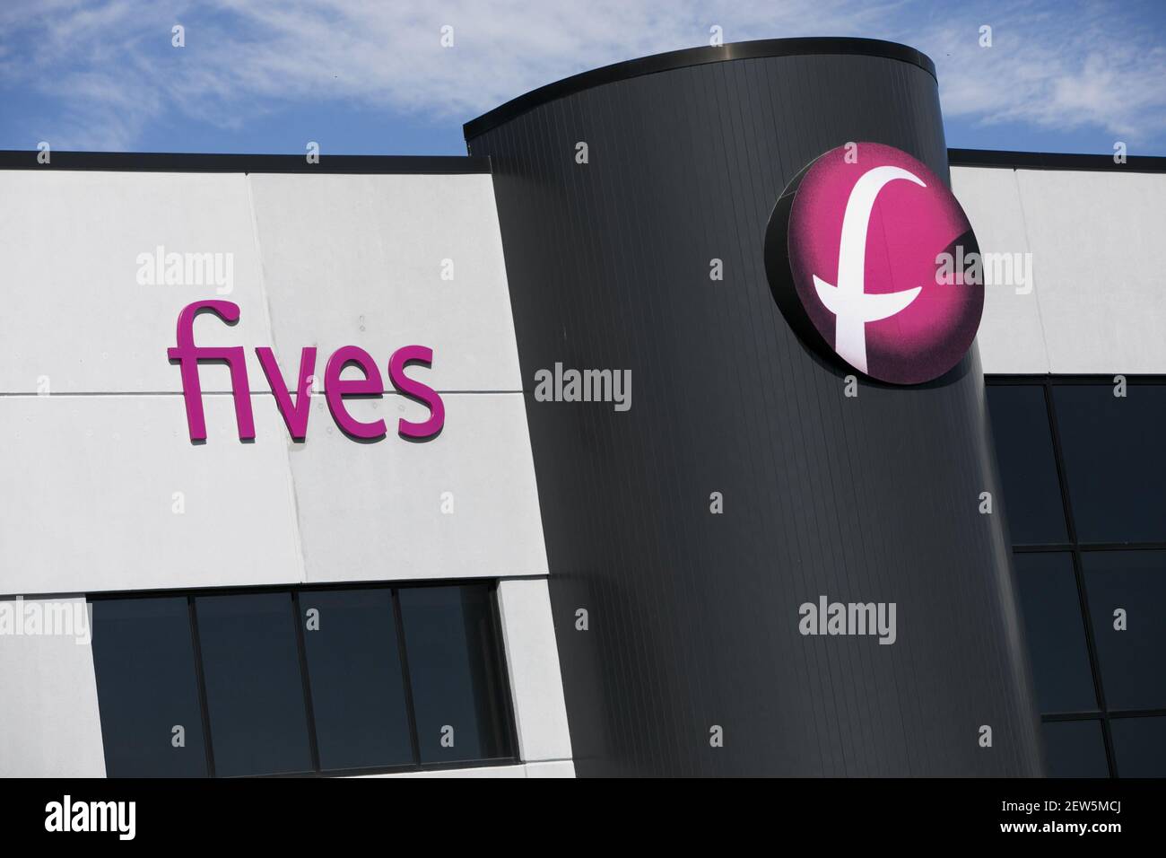 A logo sign outside of a facility occupied by the Fives Group in ...