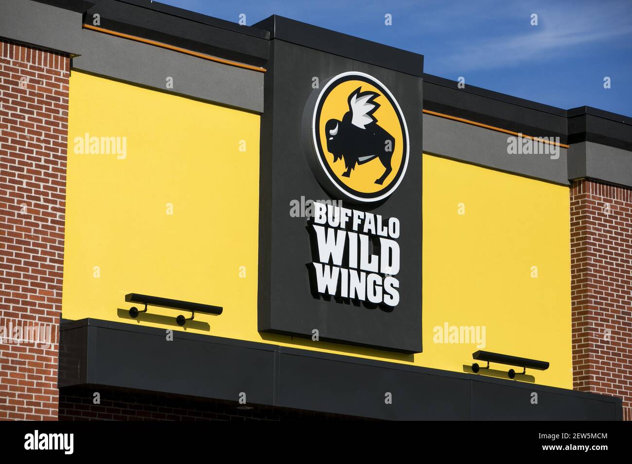 A logo sign outside of a Buffalo Wild Wings restaurant location in ...