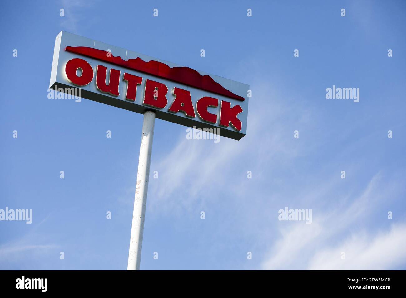 A logo sign outside of a Outback Steakhouse restaurant location in ...