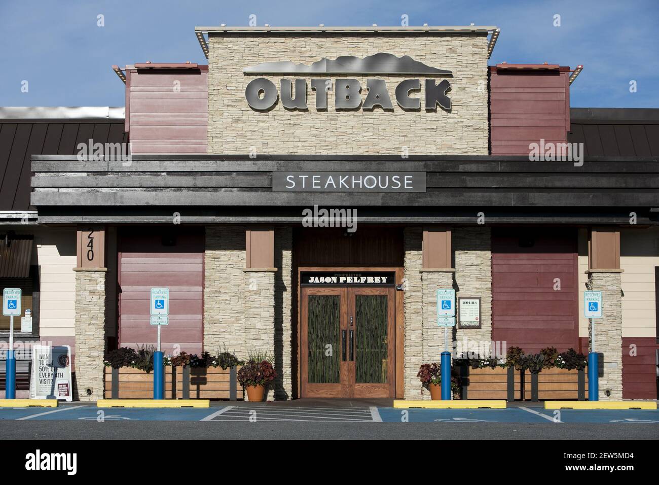 A logo sign outside of a Outback Steakhouse restaurant location in ...