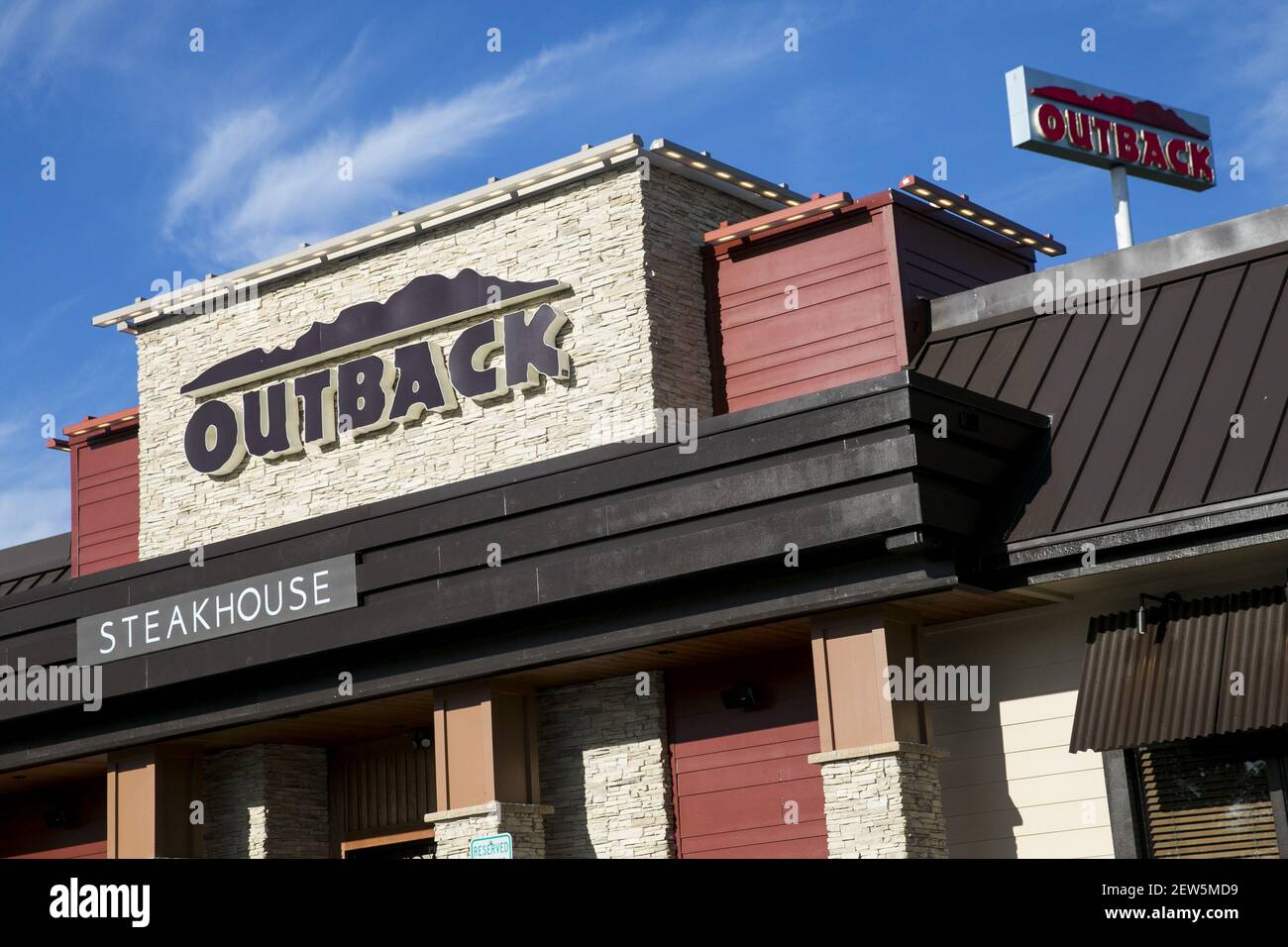 A logo sign outside of a Outback Steakhouse restaurant location in ...