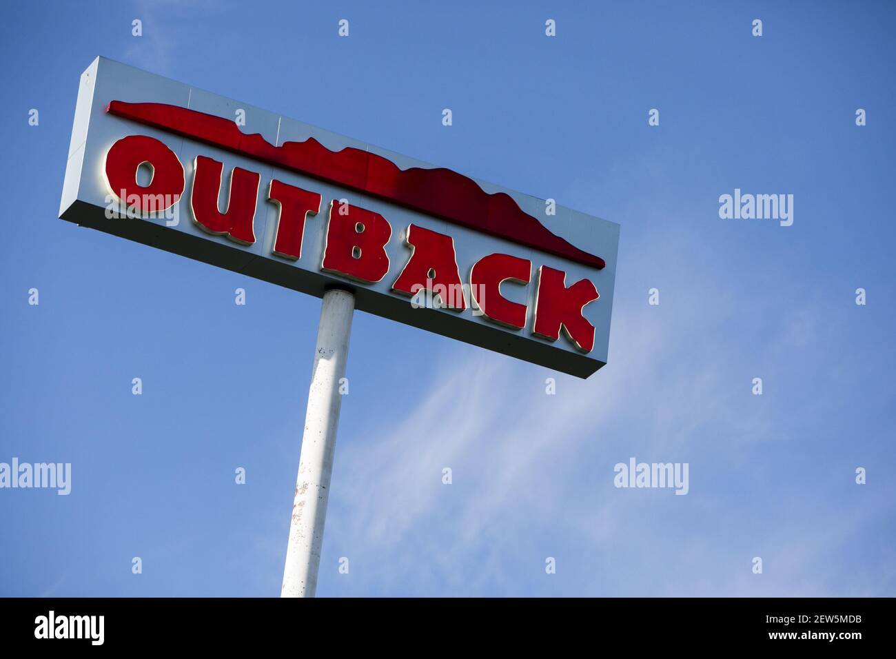 A logo sign outside of a Outback Steakhouse restaurant location in ...