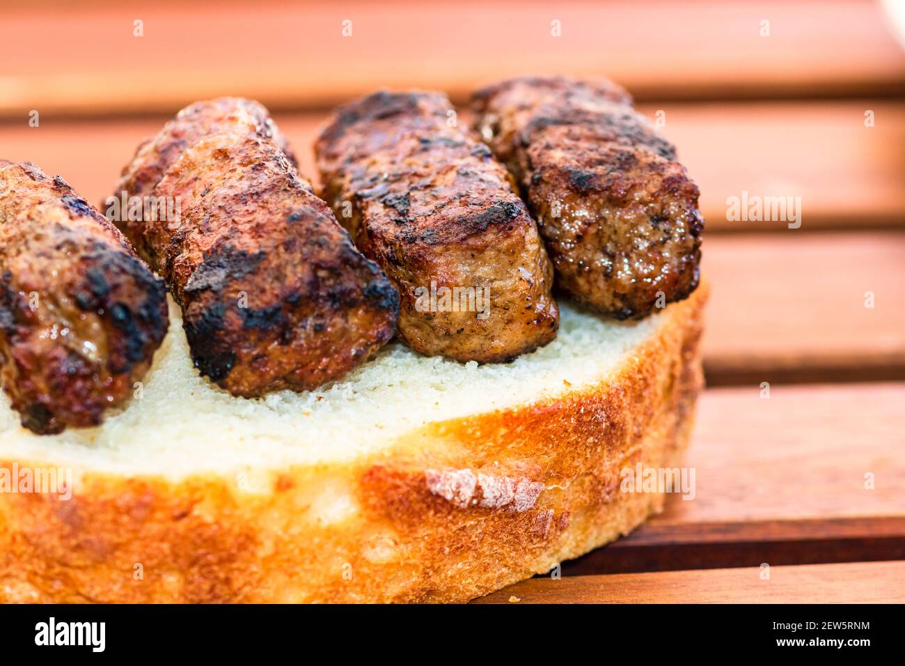 Meat rolls called mici or mititei on a slice of bread isolated Stock ...