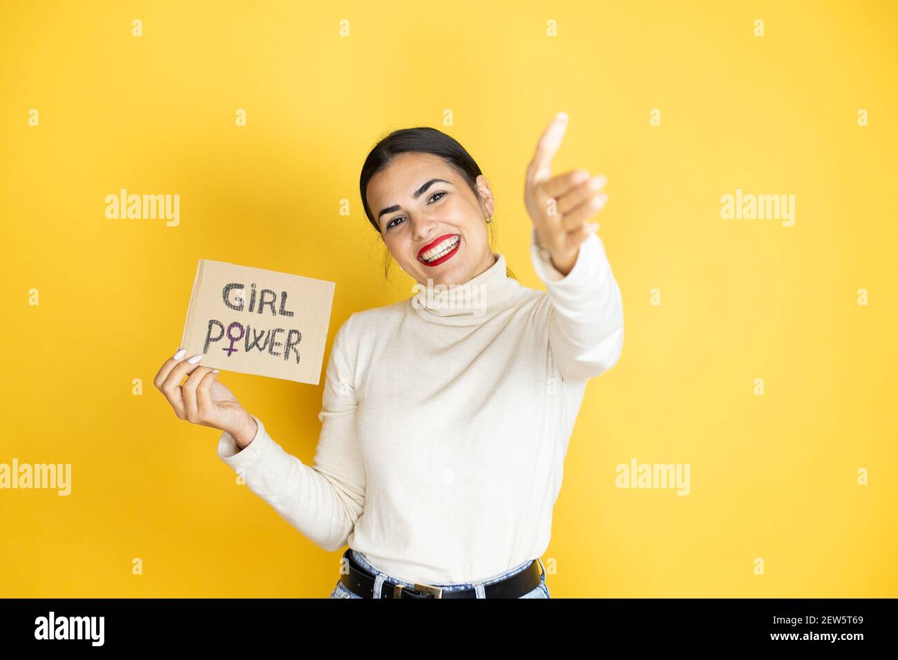 Young beautiful activist woman protesting holding poster with girl ...