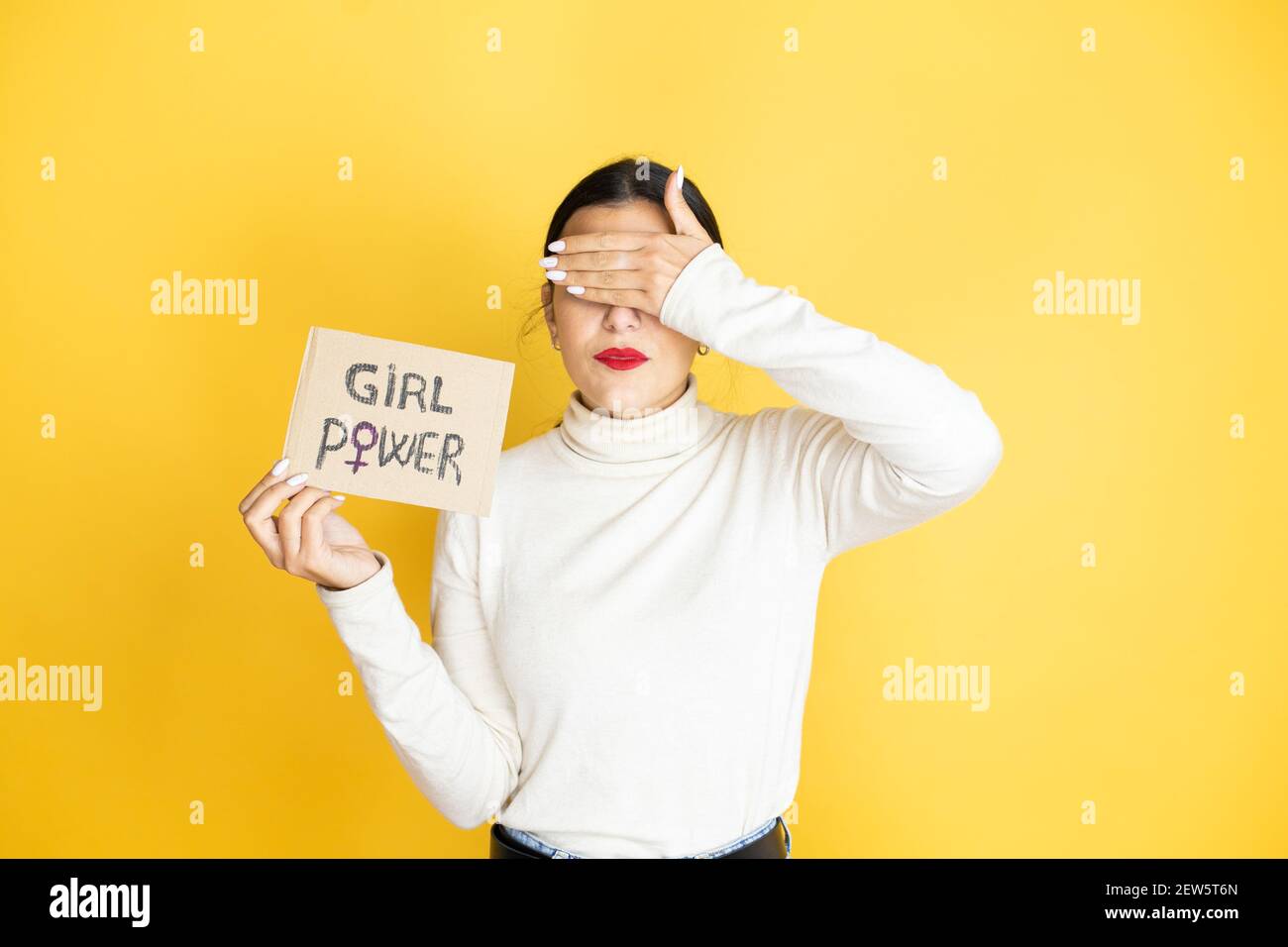 Young beautiful activist woman protesting holding poster with girl ...