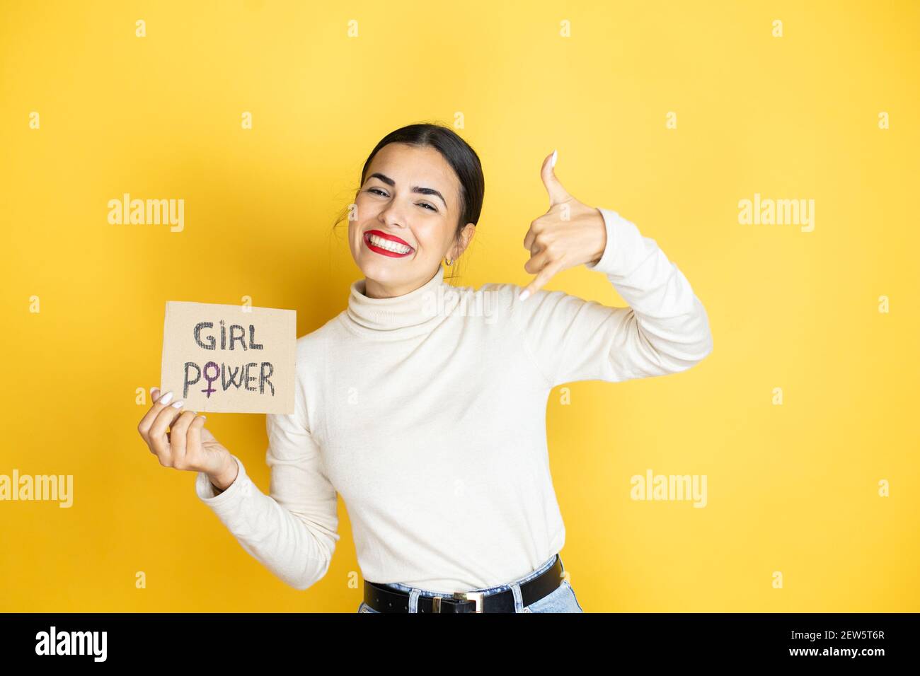 Young beautiful activist woman protesting holding poster with girl ...
