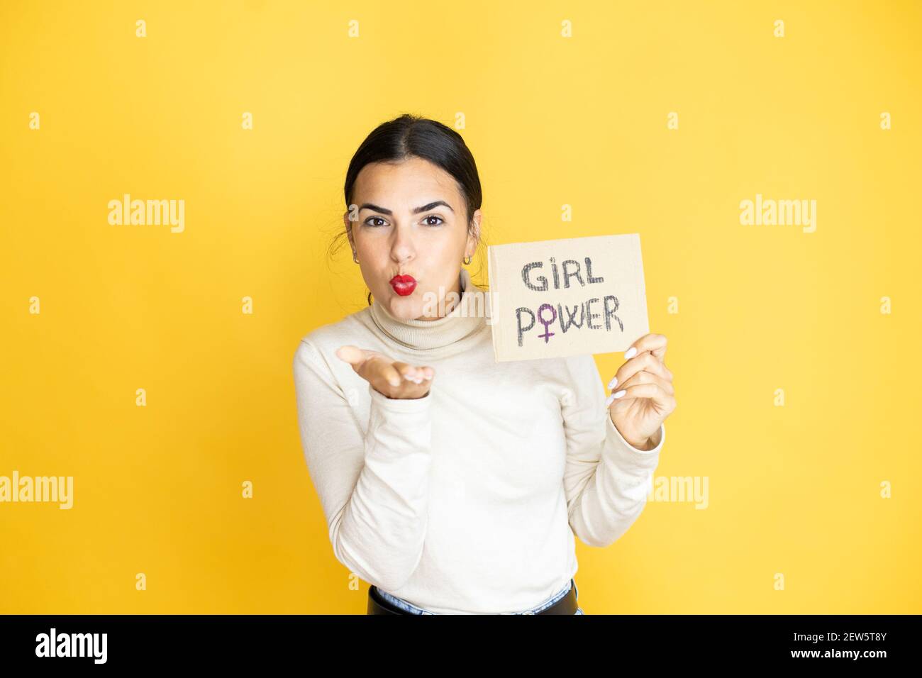 Young beautiful activist woman protesting holding poster with girl ...