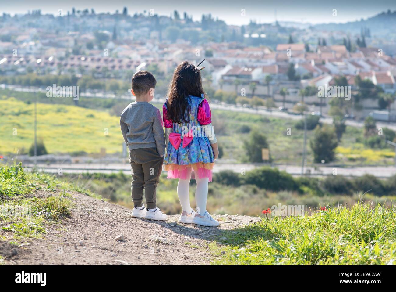 Back View Of Two Happy Toddler Friends Siblings In Nature Looking At ...