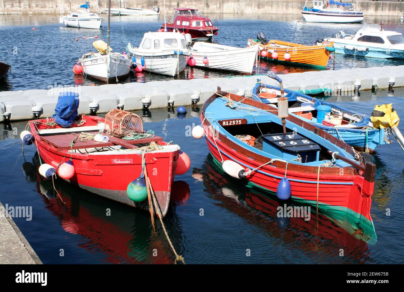 Small boats including traditional wooden fishing boat, in the harbour ...