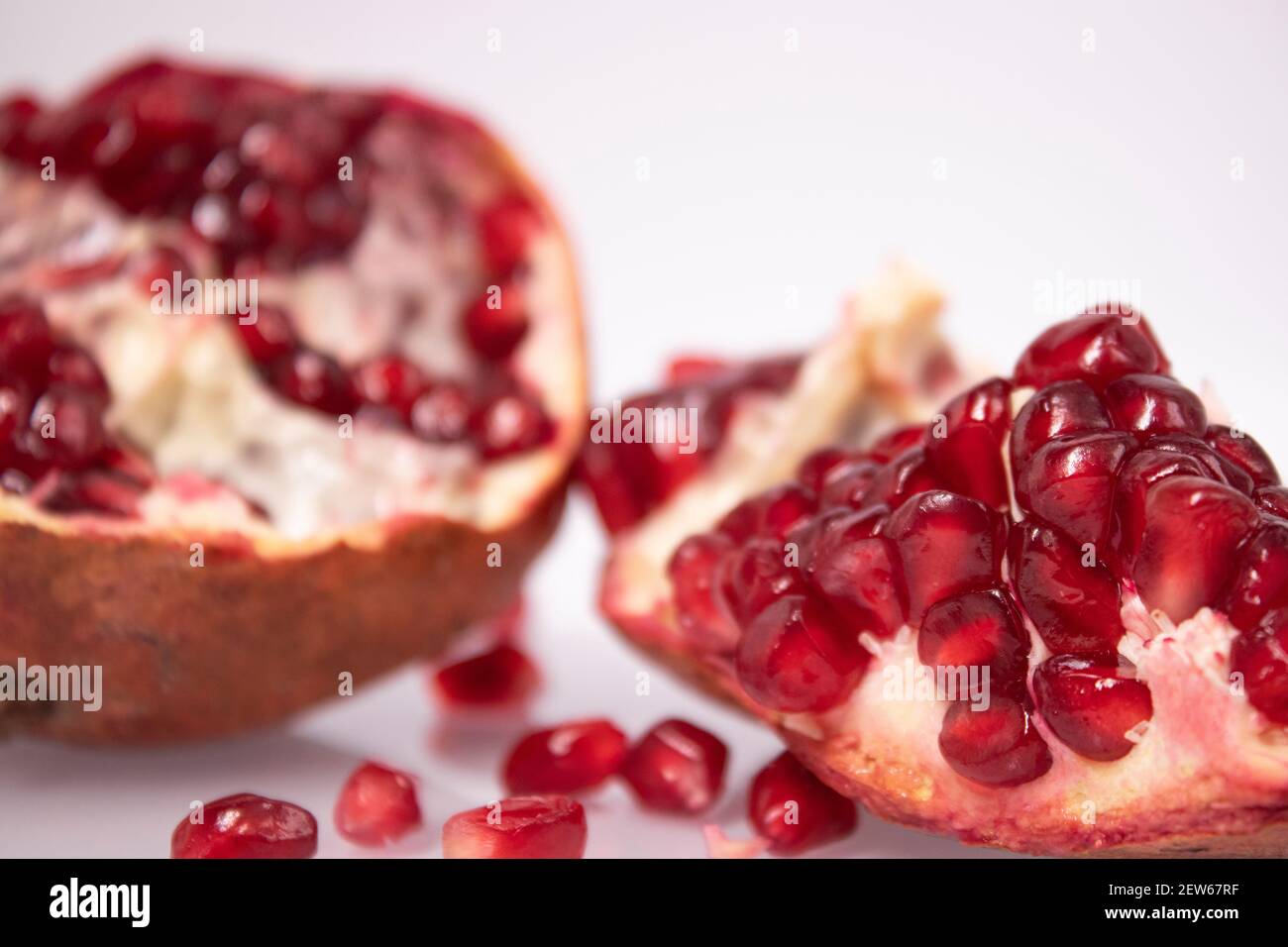 ripe fresh sliced pomegranate fruit with red seeds isolated on white ...