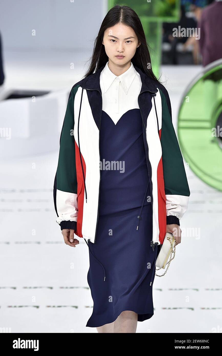 Model He Cong walks on the runway during the Lacoste Fashion Show ...