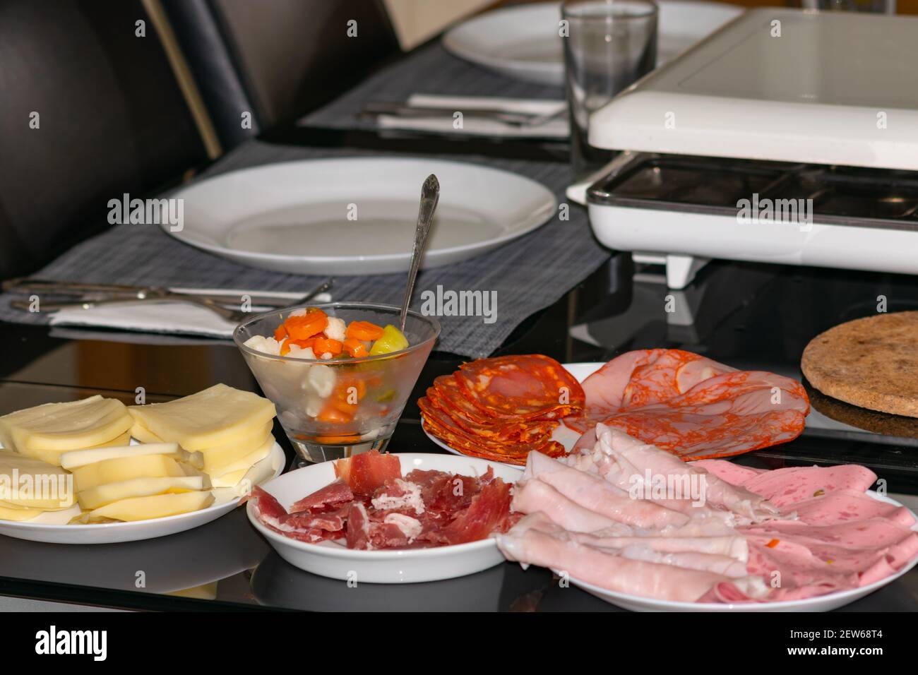 Preparing raclete swish dish, also popular in Savoie, France, based on ...