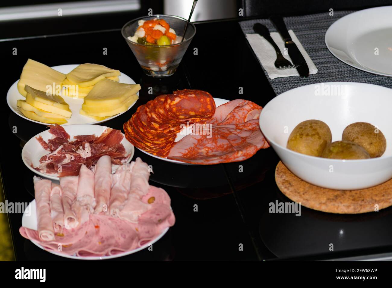 Preparing raclete swish dish, also popular in Savoie, France, based on ...