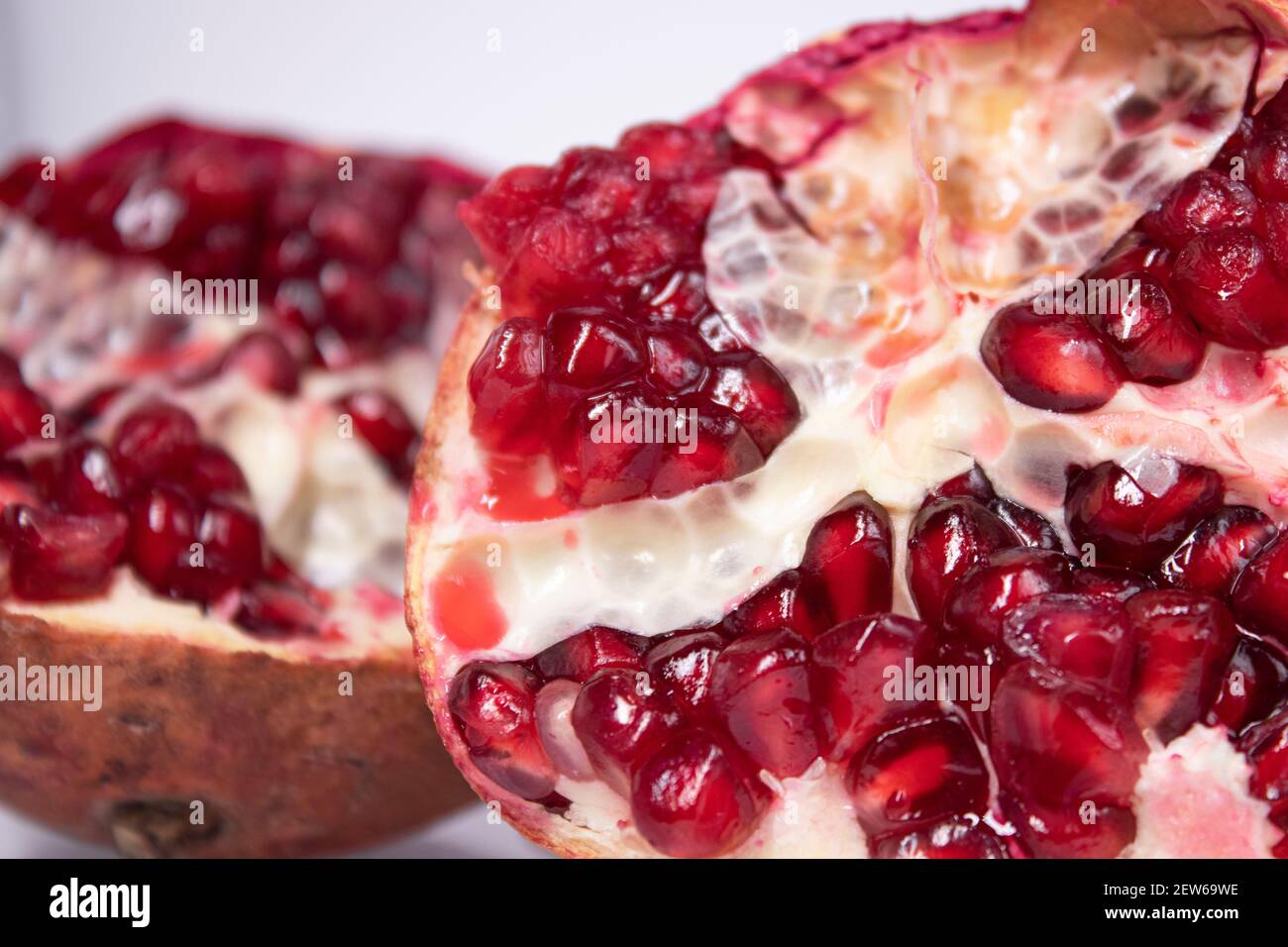 ripe fresh sliced pomegranate fruit with red seeds isolated on white ...