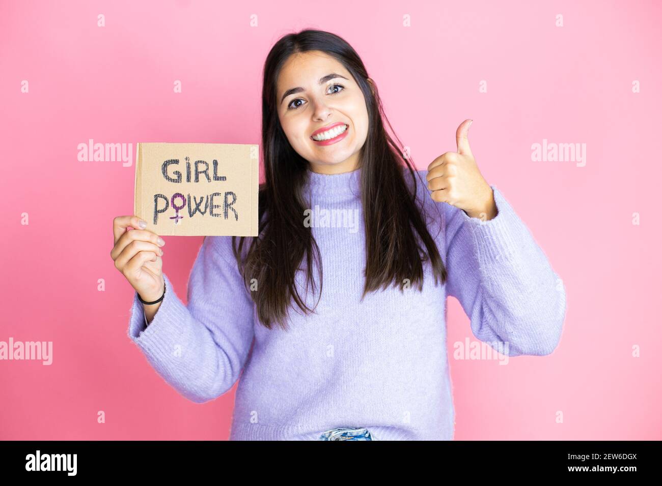 Young beautiful activist woman protesting holding poster with girl ...
