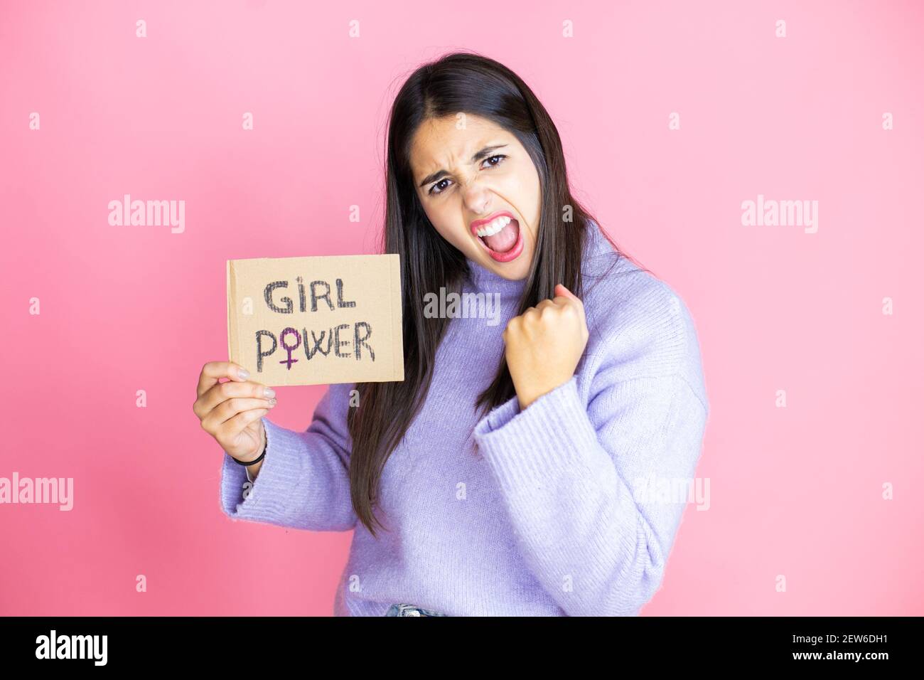 Young beautiful activist woman protesting holding poster with girl ...