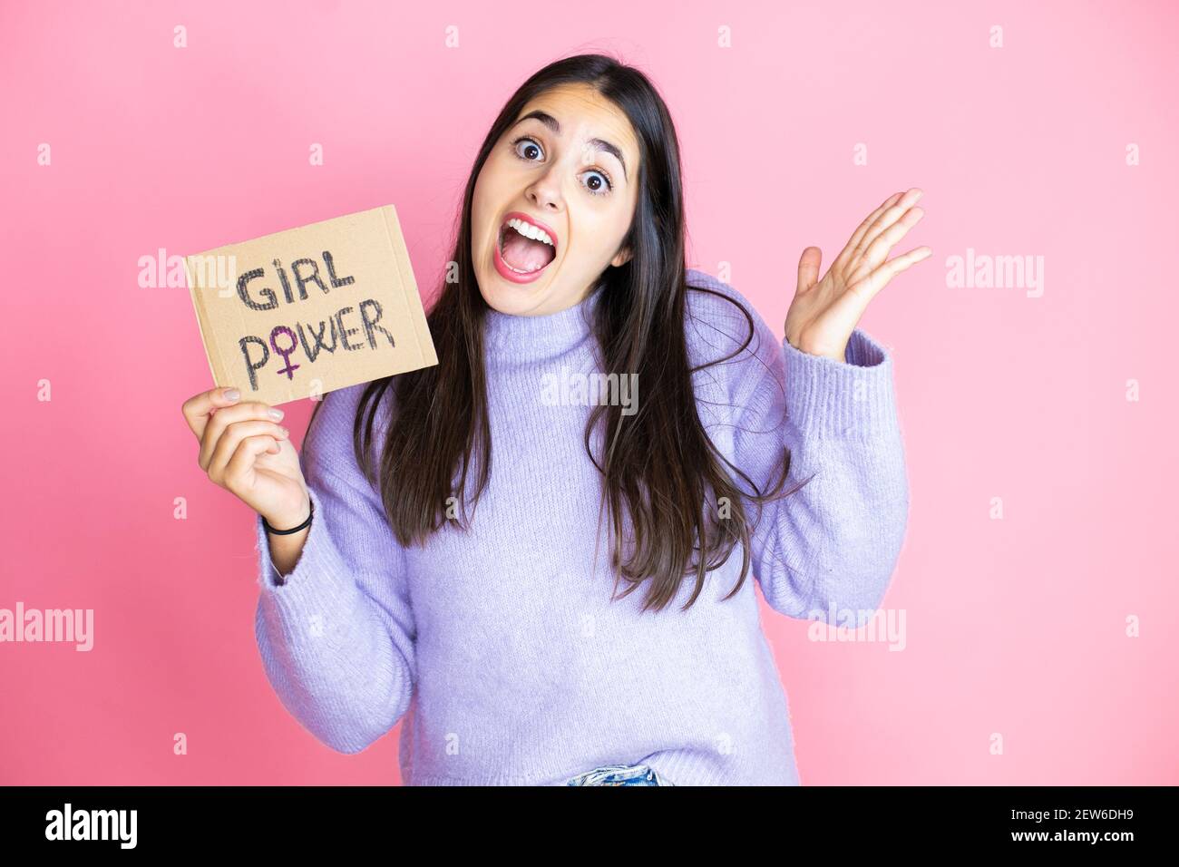 Young beautiful activist woman protesting holding poster with girl ...