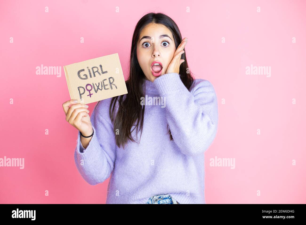 Young beautiful activist woman protesting holding poster with girl ...