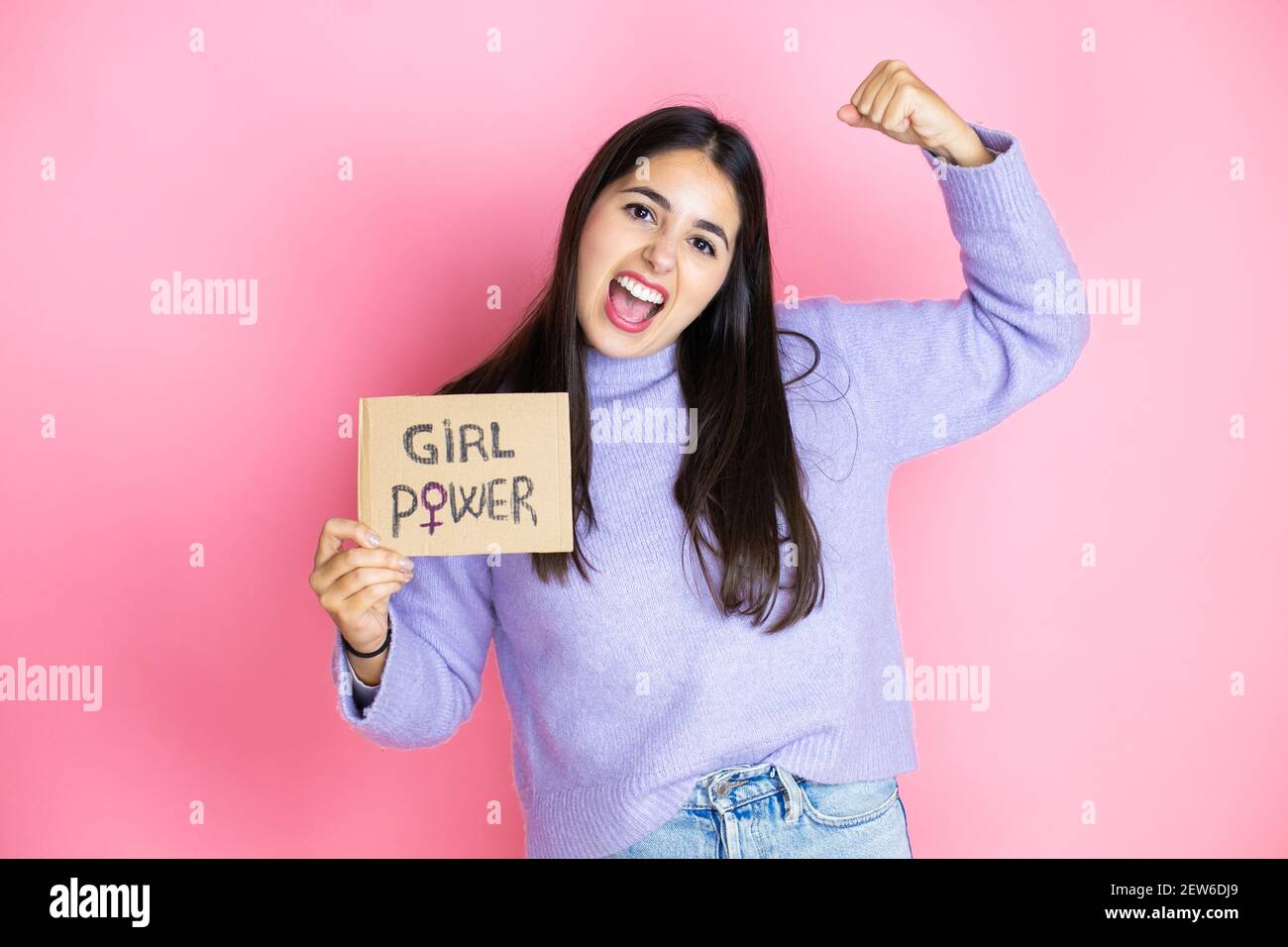 Young beautiful activist woman protesting holding poster with girl ...