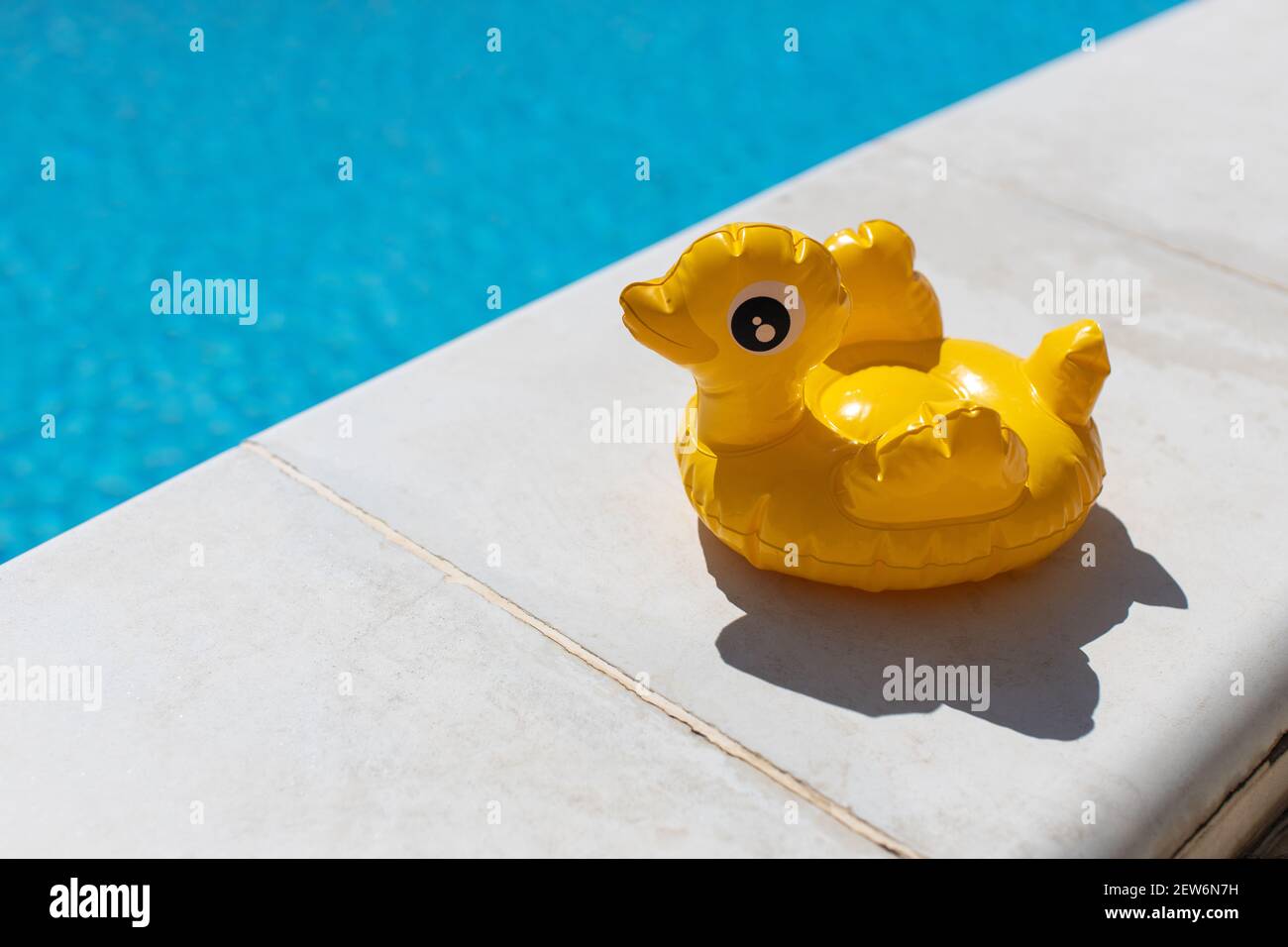 Inflatable yellow mini duck, cocktail stand near swimming pool on ...