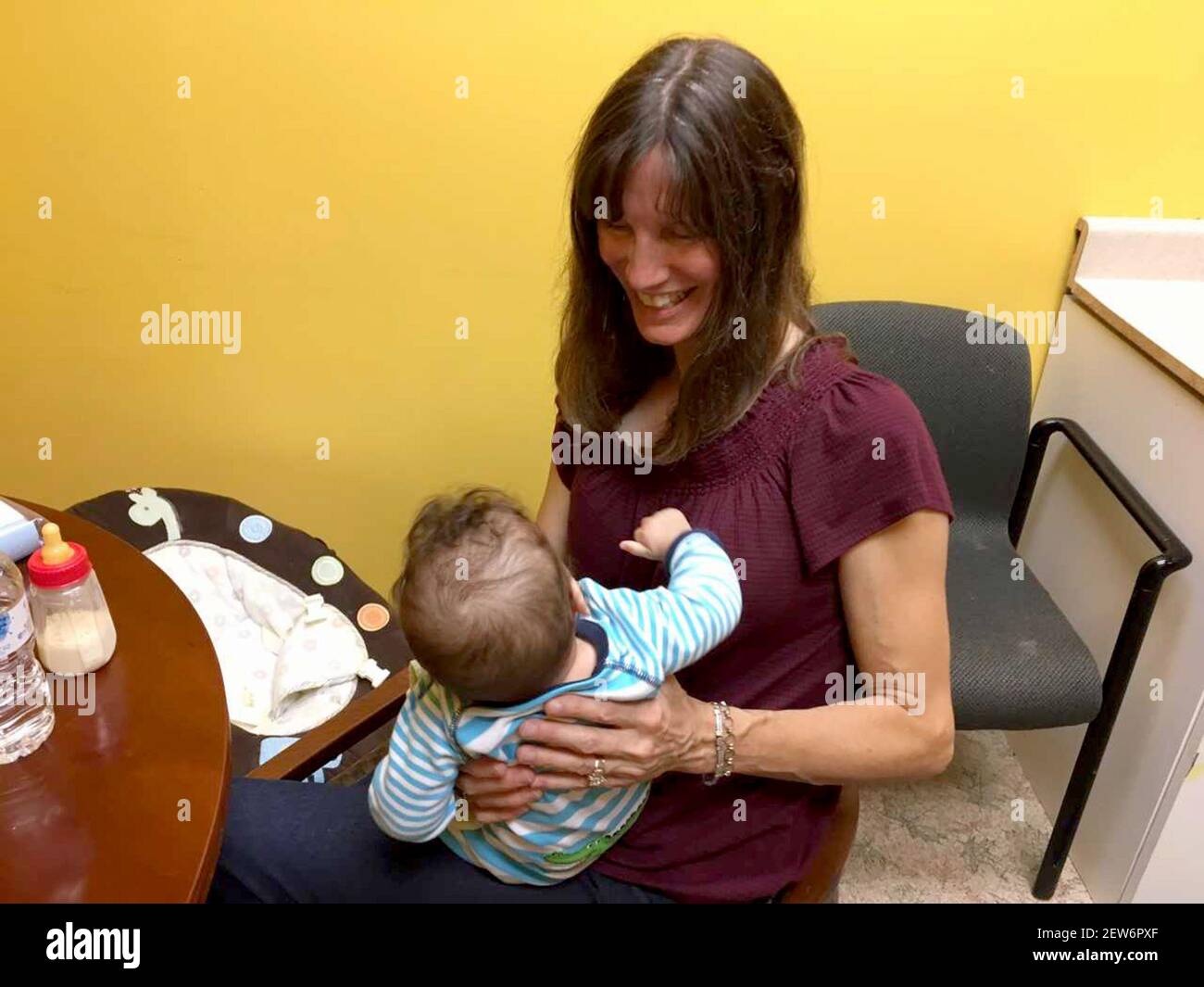 Susan Vrenios of Hawthorne Woods smiles at one of the two babies under ...