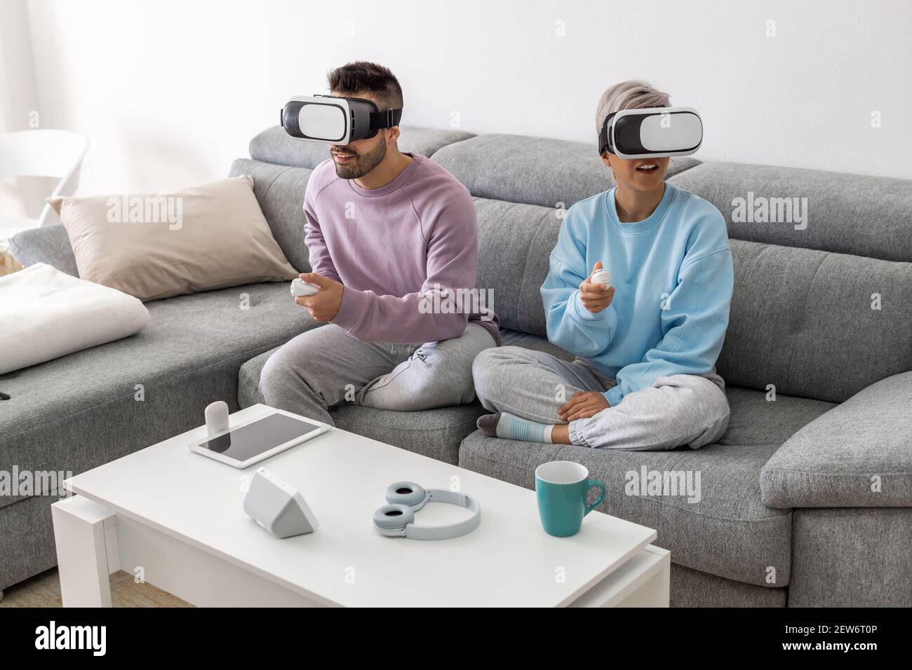 A couple plays a game in virtual reality wearing virtual reality ...