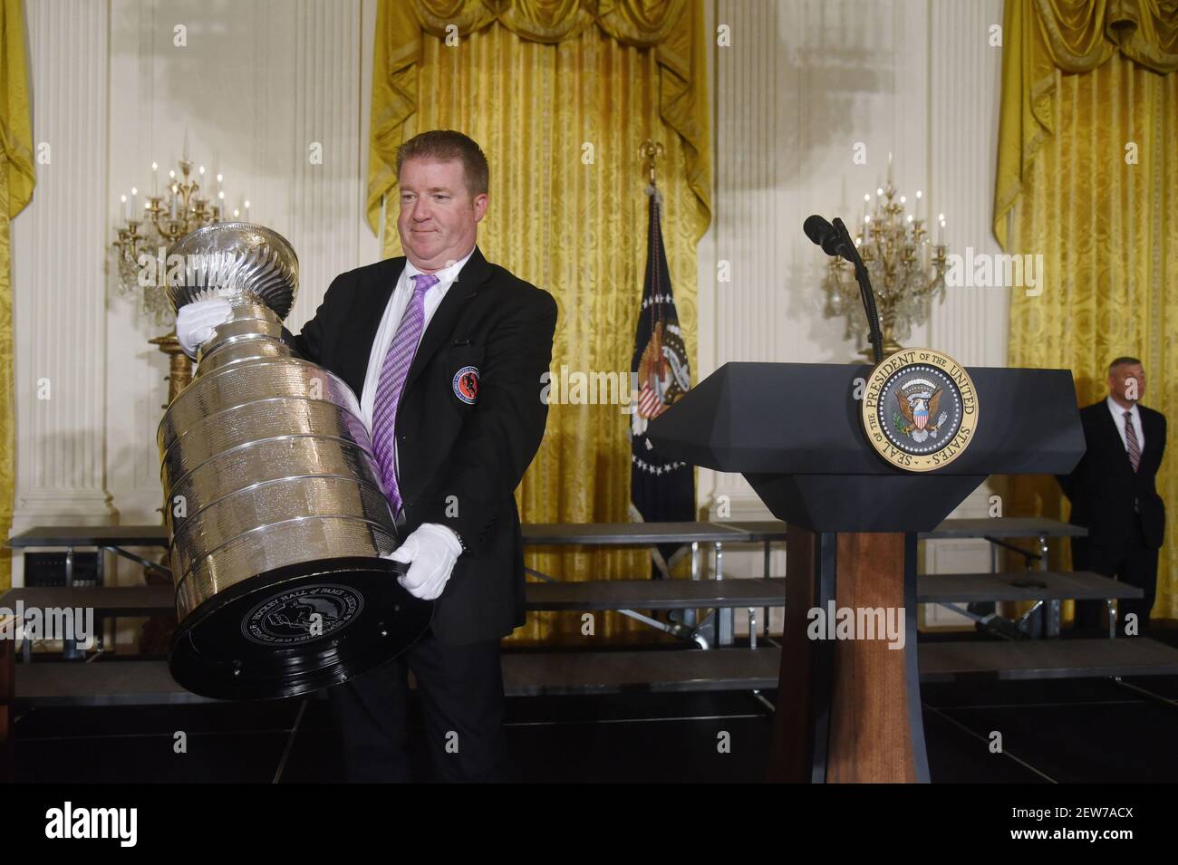 Keeper of the cup Mike Bolt carries the Stanley Cup into the East Room ...