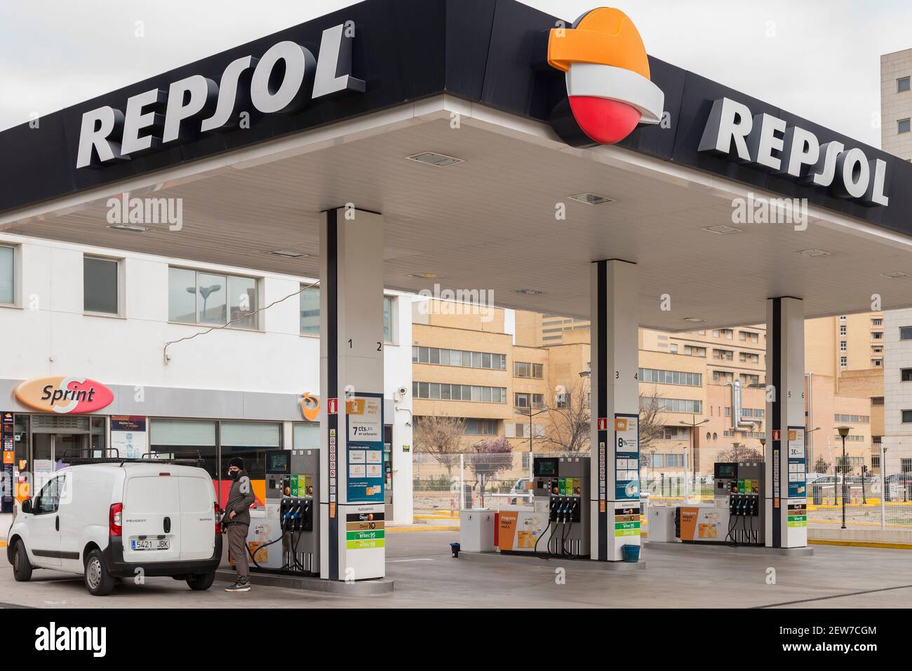 A man refilling gasoline at a Repsol service station Stock Photo - Alamy