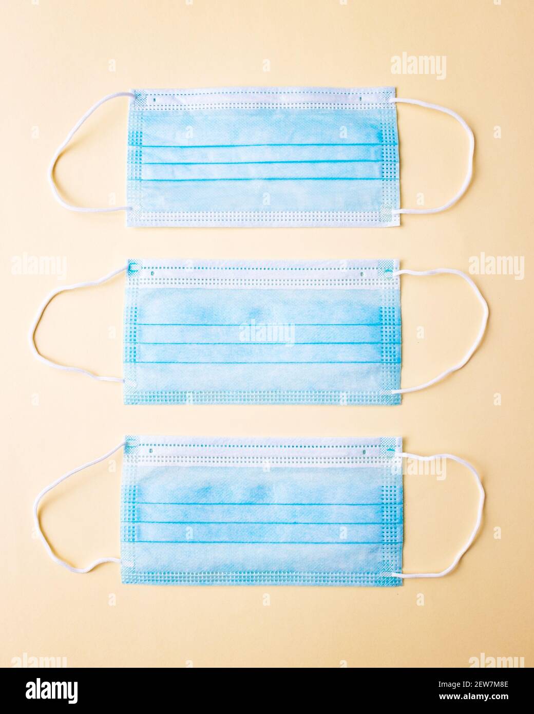 Three surgical masks on yellow background. Ideal concept of double and ...