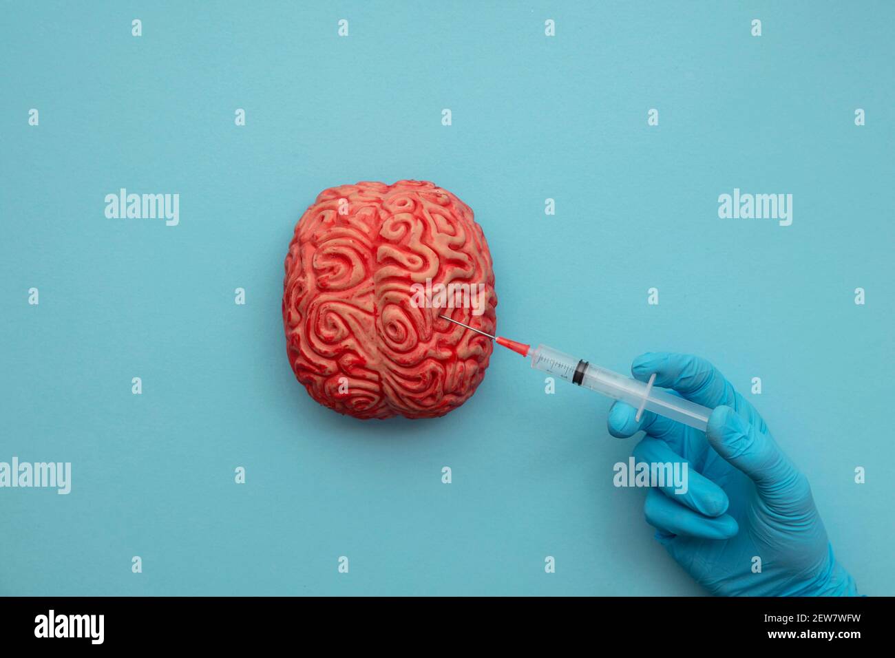 Doctor injecting a brain with a syringe. Mental illness concept Stock ...