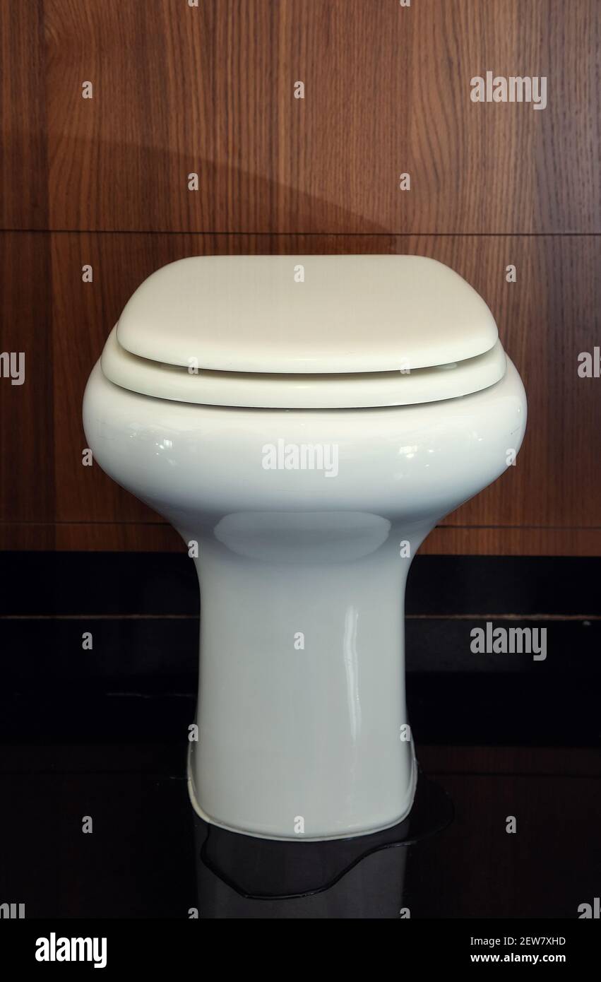 White leaky toilet installation with a puddle under the toilet Stock ...
