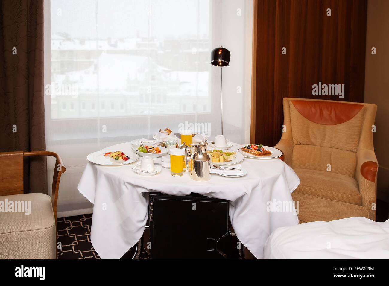 Served breakfast in a hotel room on a roll-out table on a white ...