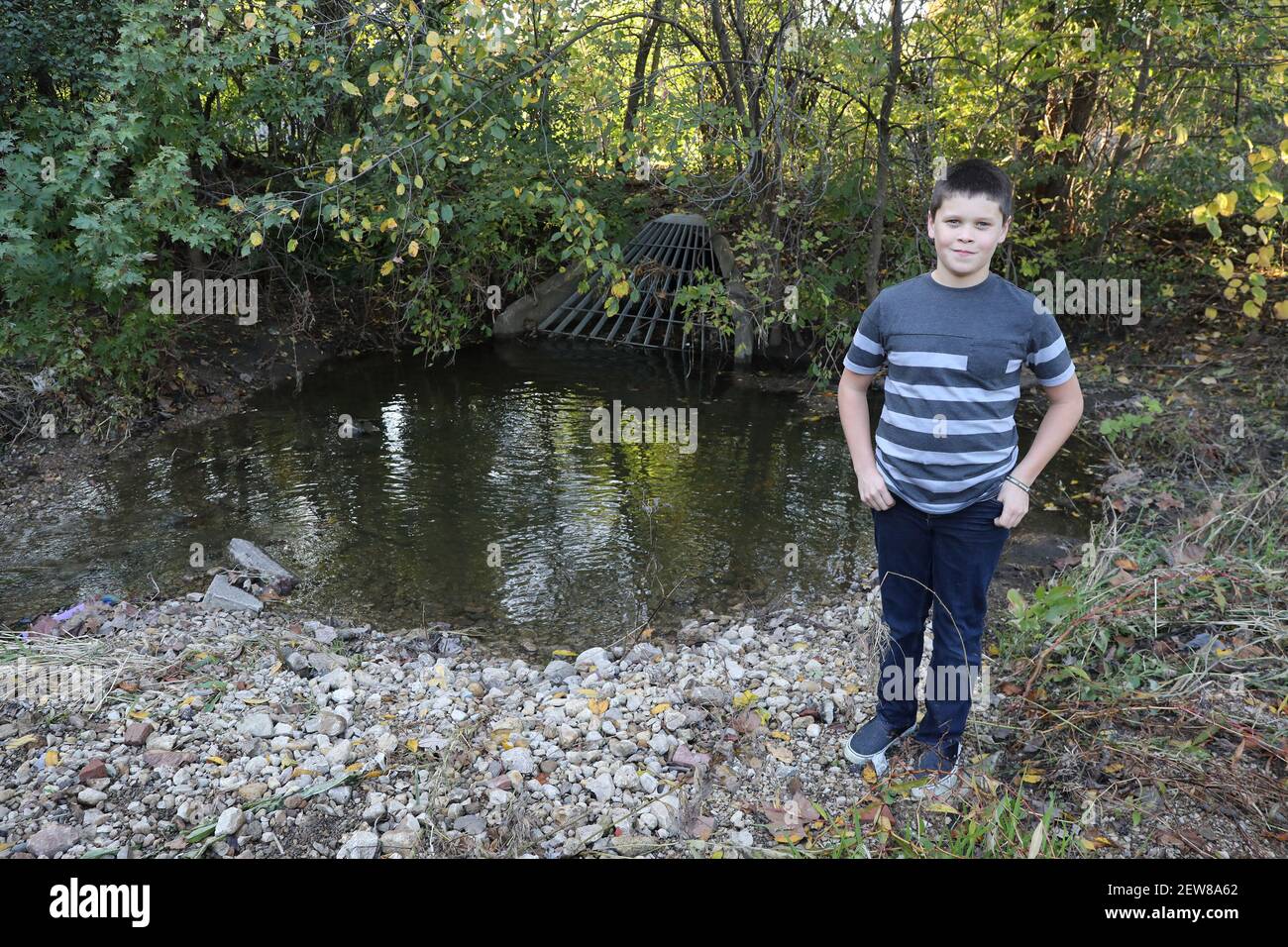 P.J. Doppke, 10, at the creek where he emerged after he was swept into ...