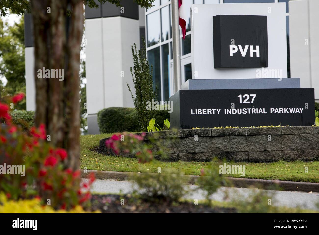A logo sign outside of a facility occupied by the PVH Corporation ...