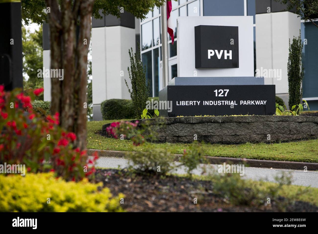 A logo sign outside of a facility occupied by the PVH Corporation ...