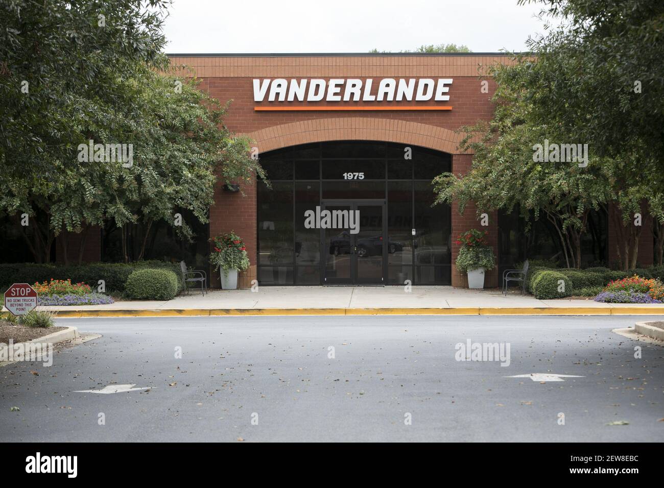 A logo sign outside of a facility occupied by Vanderlande Industries in ...