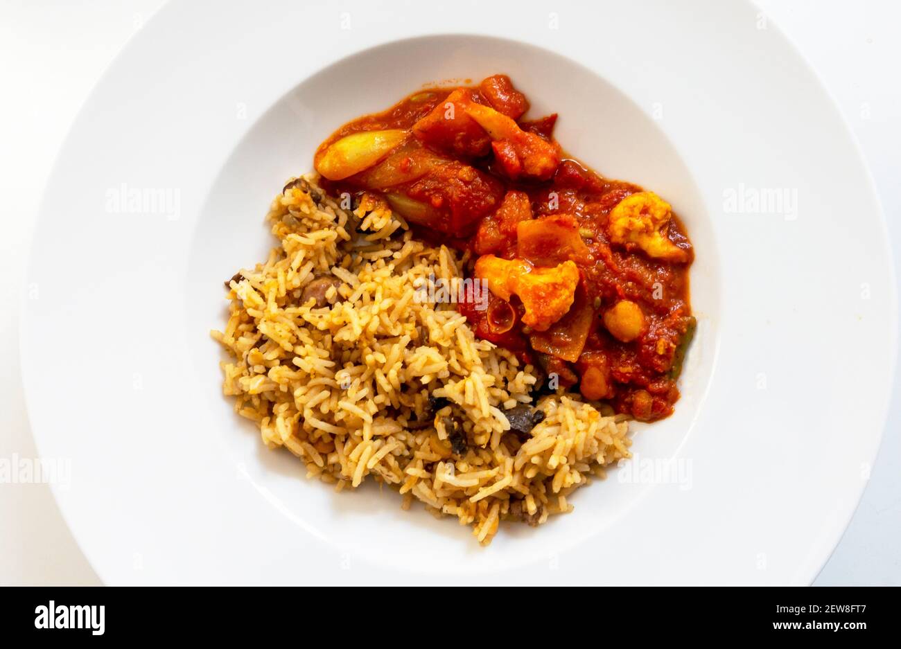 A vegan meal of Indian vegetable curry and rice with mushrooms Stock ...