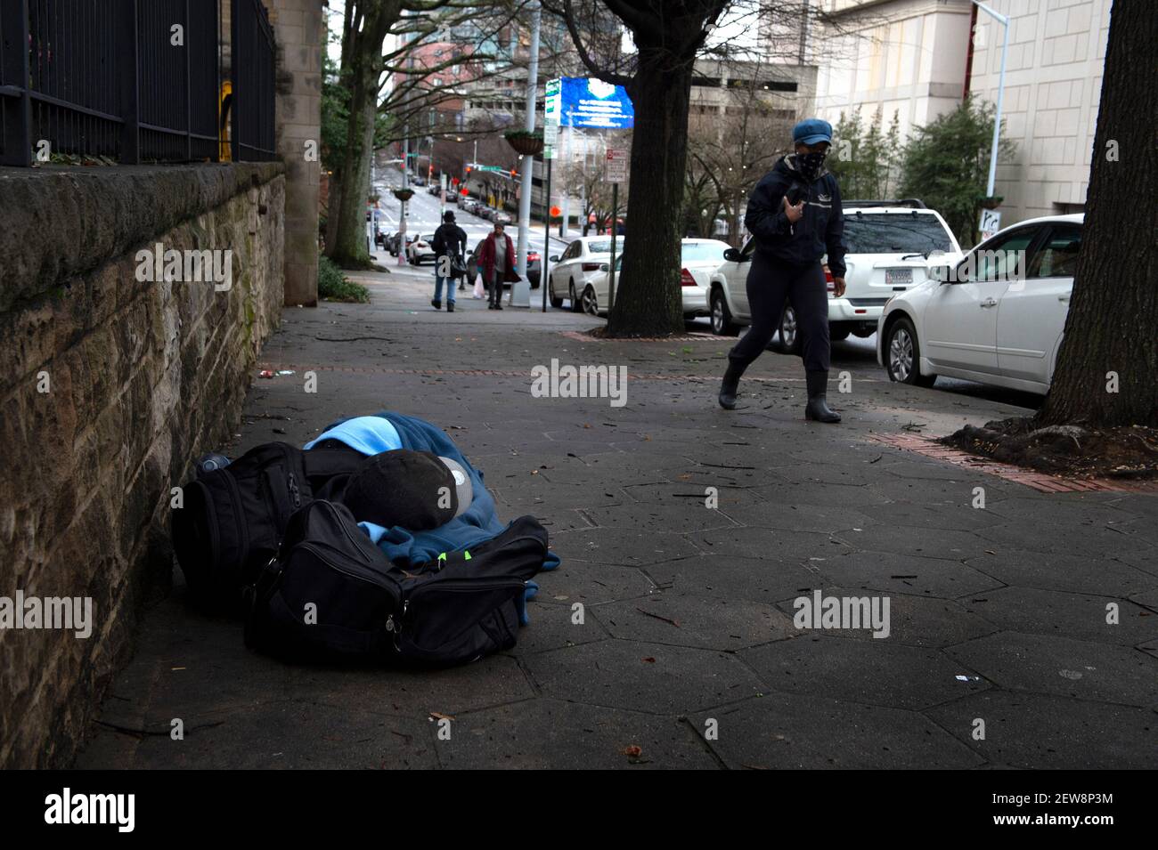 Atlanta, GA, USA. 2nd Mar, 2021. A. homeless man sleeps on a sidewalk ...