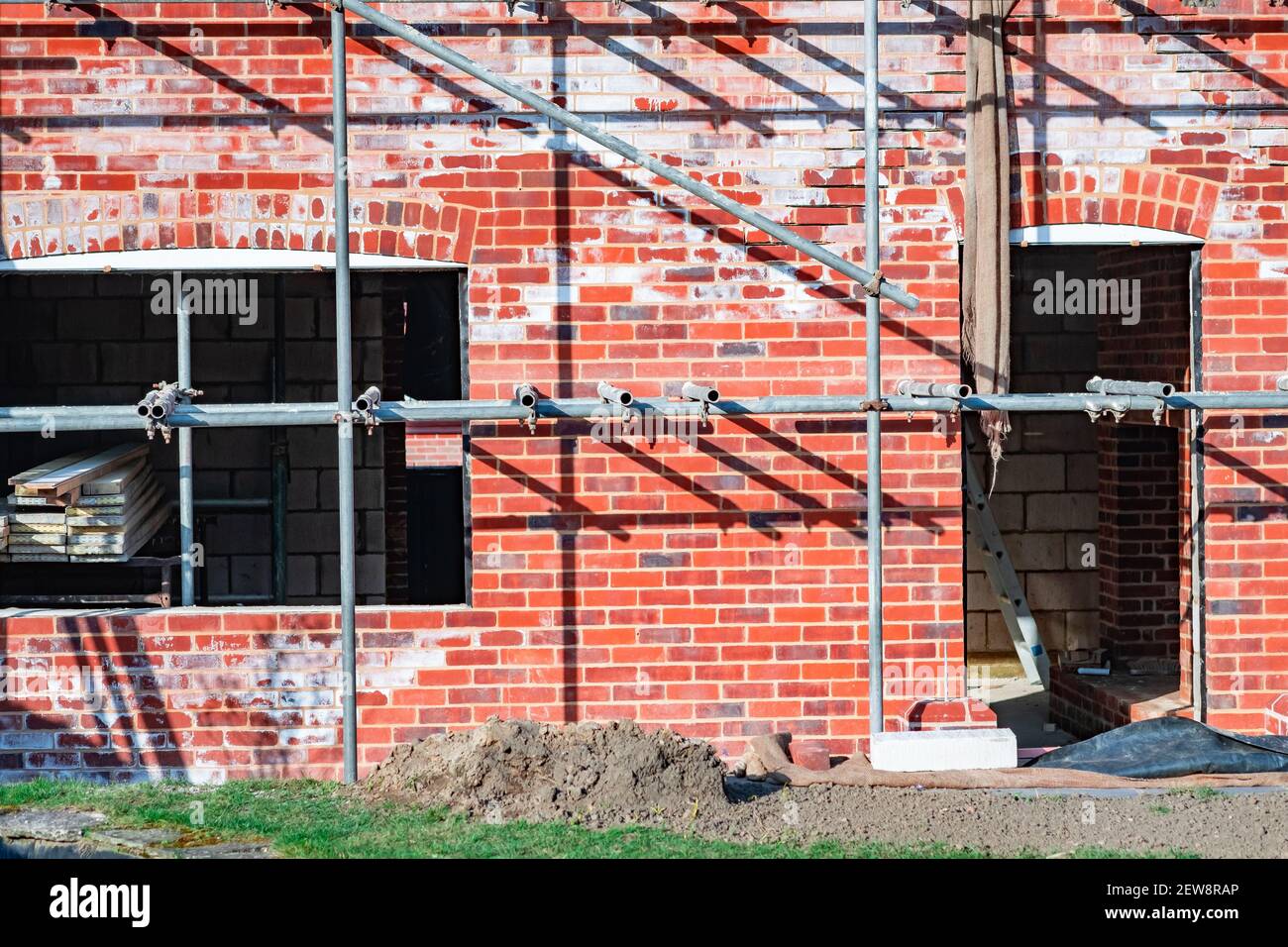 Derelict brick building surrounded by scaffolding under renovation ...
