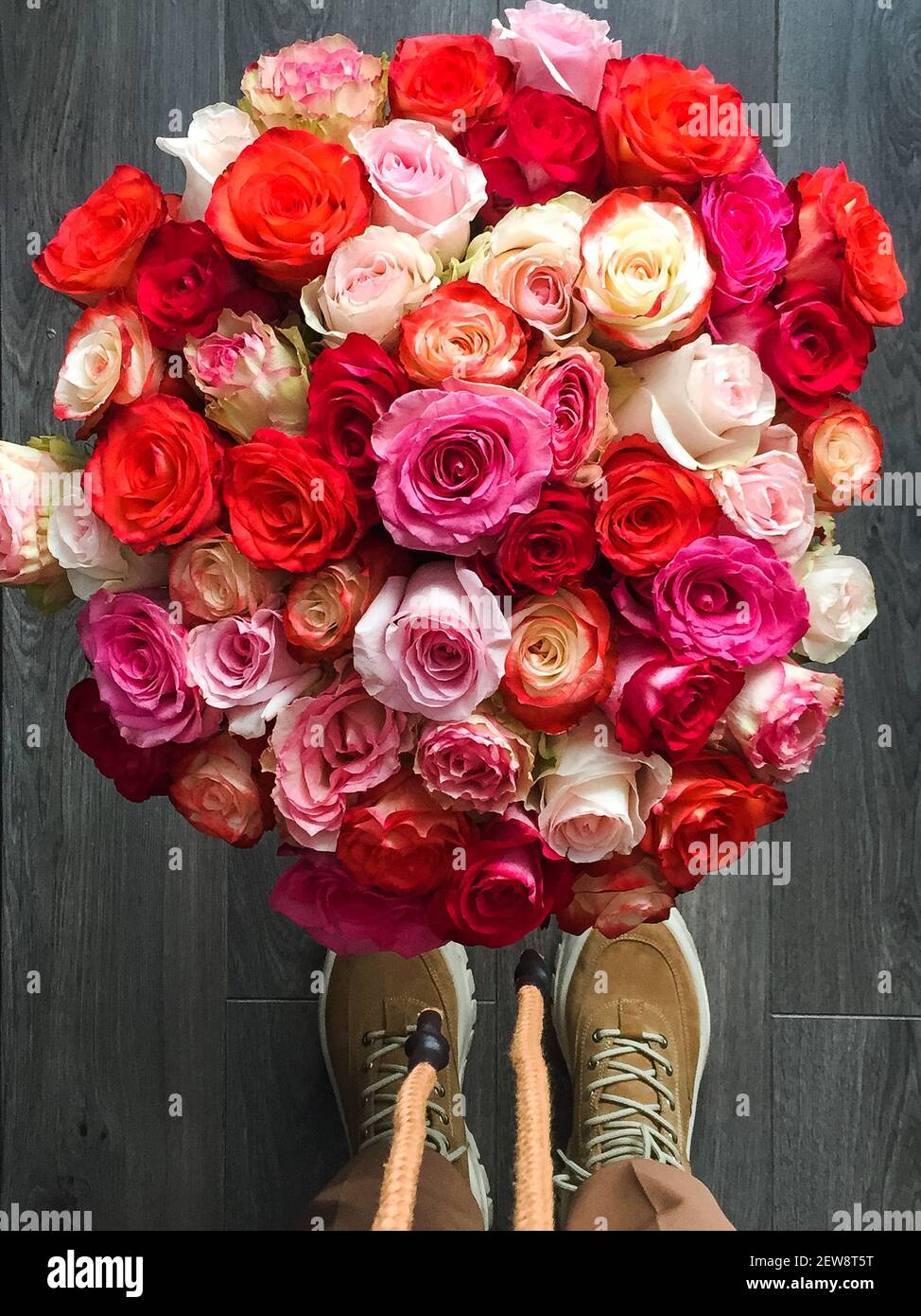 A large bouquet of roses at the girl's feet Stock Photo - Alamy