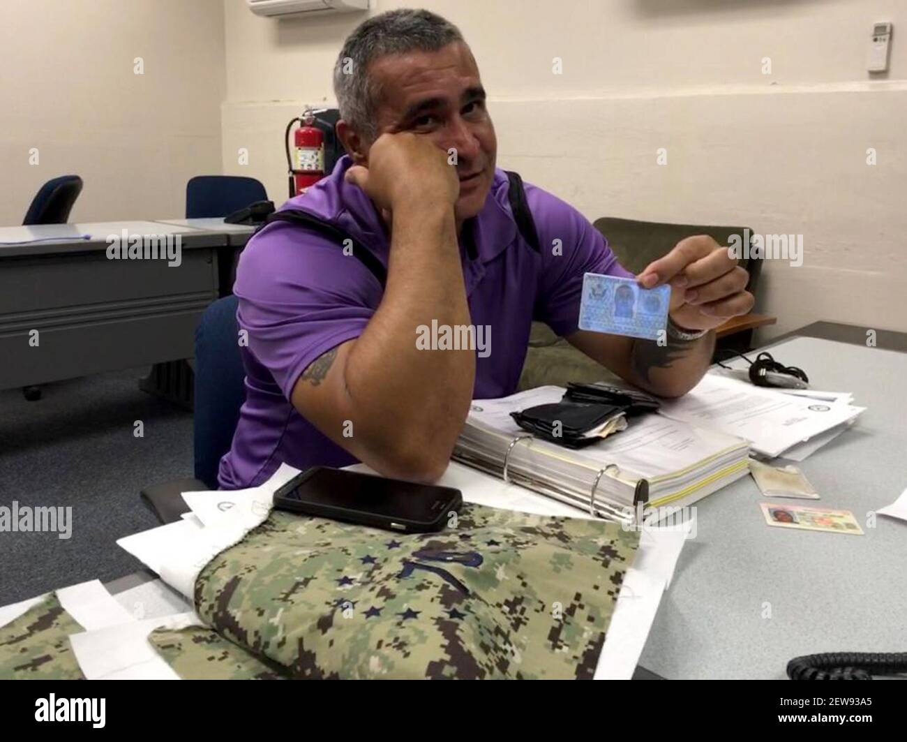 Pentagon contractor Ismael Gonzalez holds up his veteran's ...