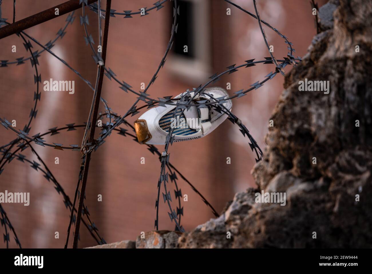 barbed wire fence with shoe Stock Photo - Alamy