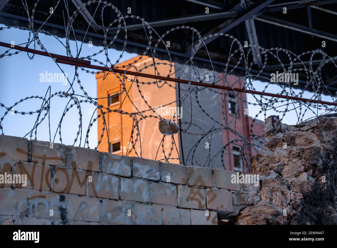 shoe stuck in barbed wire in urban environment Stock Photo - Alamy