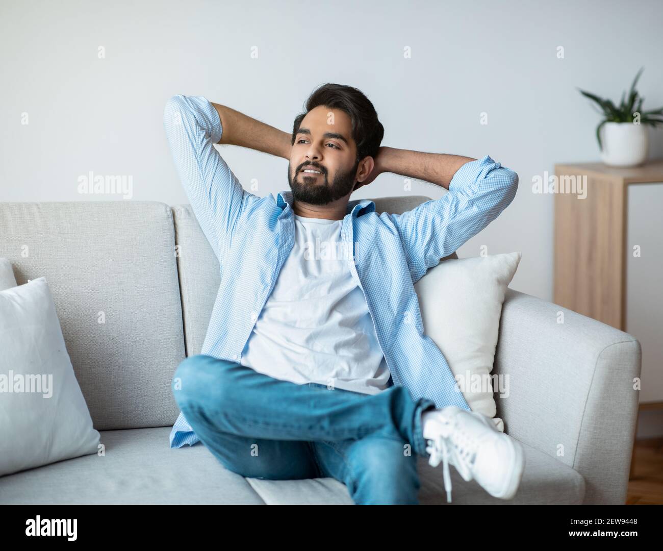 Domestic Rest. Arab Man Leaning Back On Sofa With Hands Behind Head ...